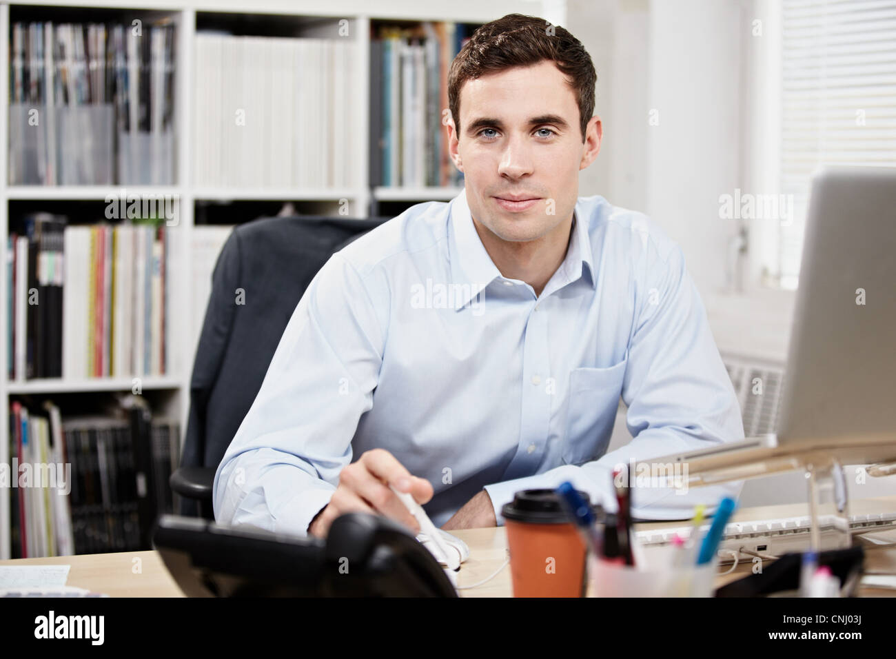 Office worker at his desk Stock Photo - Alamy