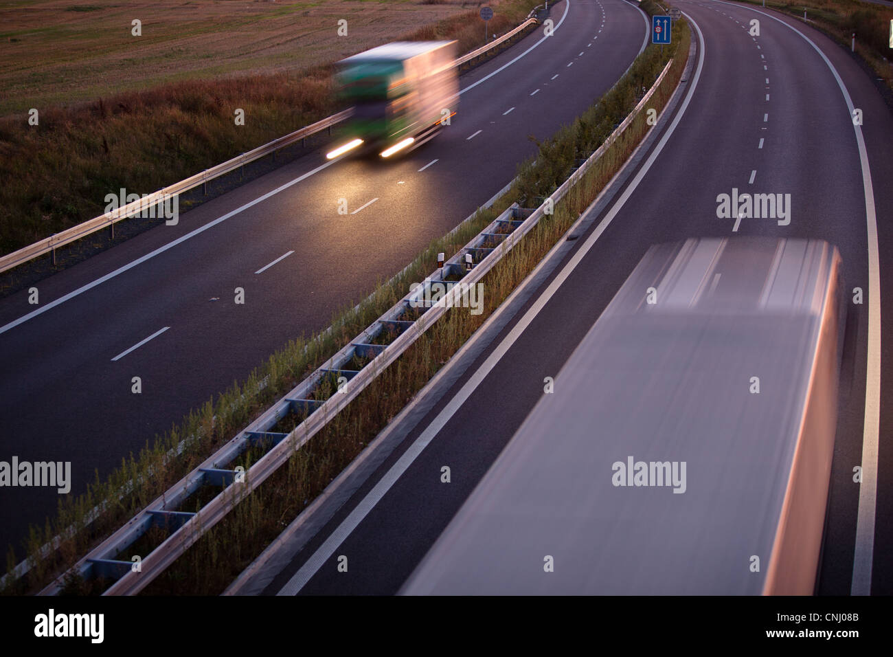 highway traffic - motion blurred truck on a highway/motorway/speedway ...