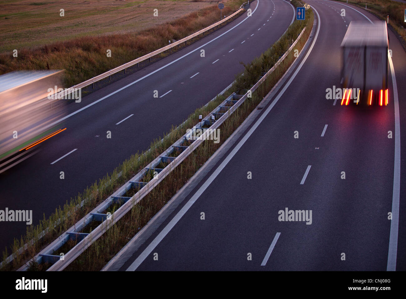 highway traffic - motion blurred truck on a highway/motorway/speedway ...