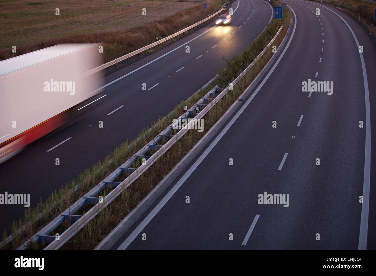 highway traffic - motion blurred truck on a highway/motorway/speedway ...