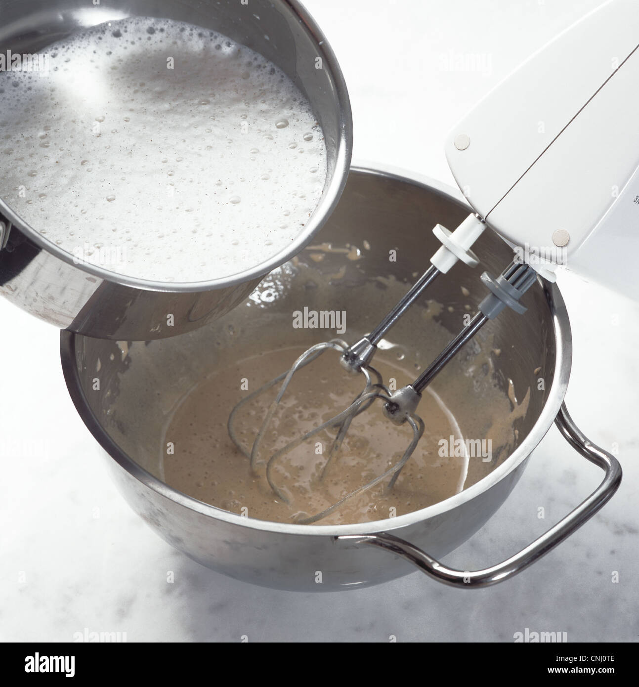 Adding hot milk Stock Photo - Alamy