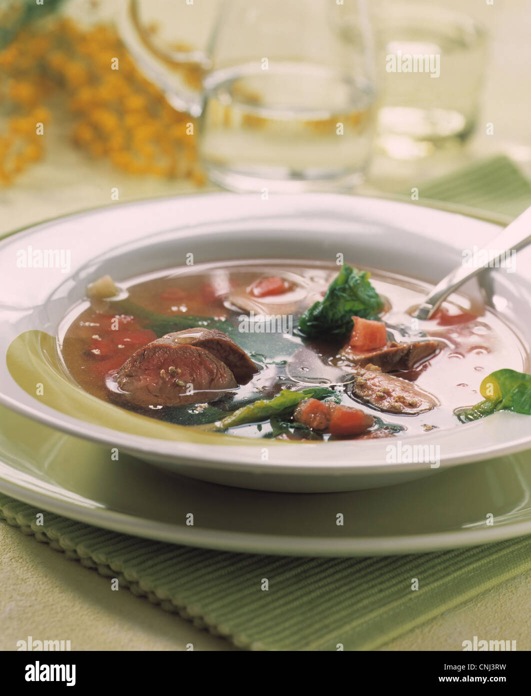 Clear brew with spinach and lamb - fillet Stock Photo - Alamy