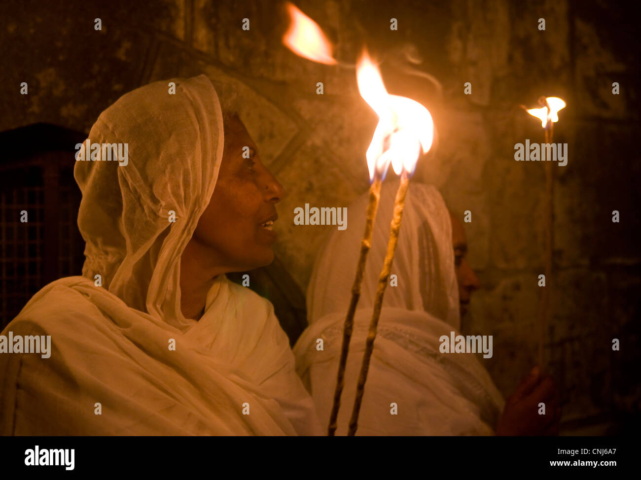 Ethiopian Orthodox worshipers hold candles during the Holy fire ...