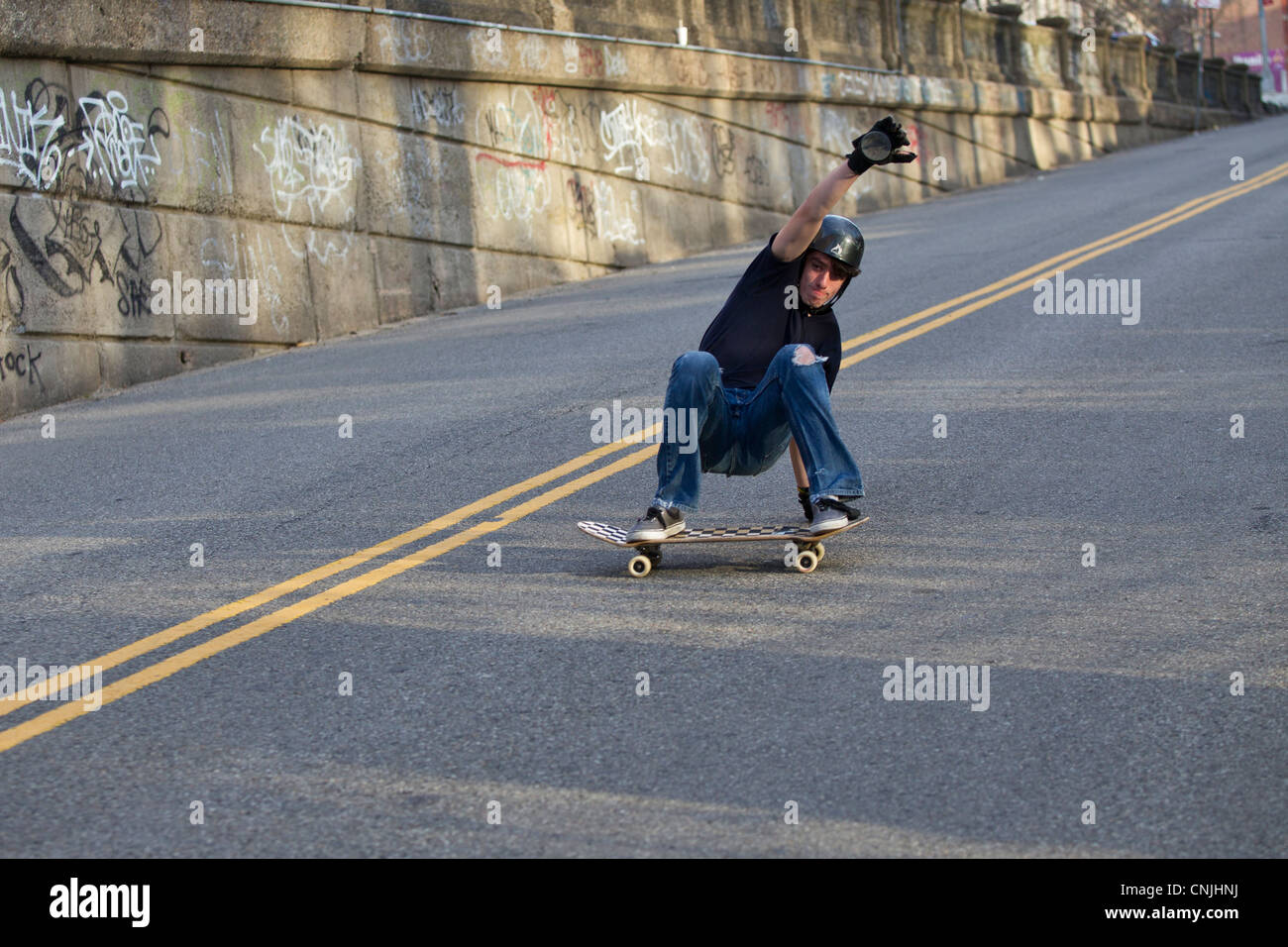Young male skateboarder on urban street Stock Photo - Alamy