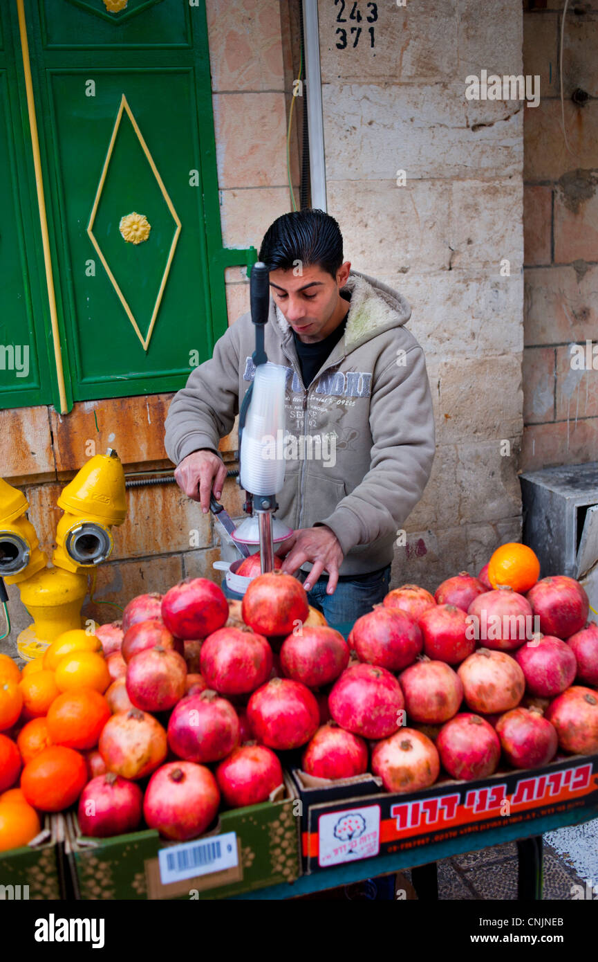 Middle East Israel Old Jerusalem a young man squeezes juices from ...