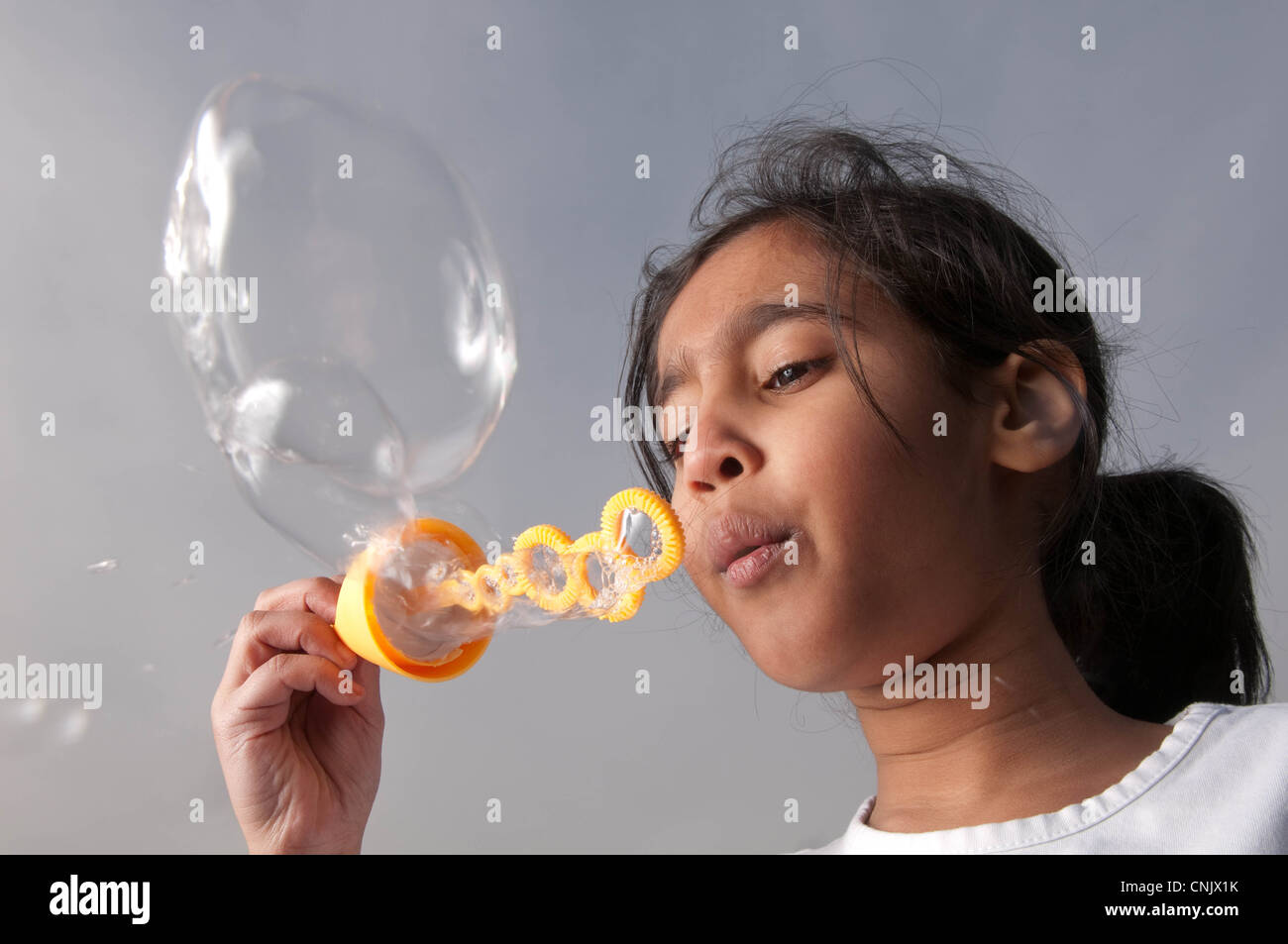 Young child blowing bubbles Stock Photo - Alamy