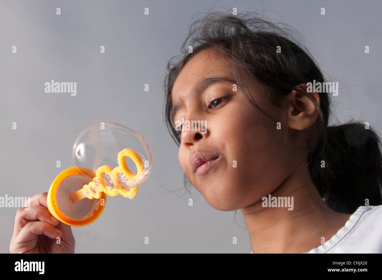 Young child blowing bubbles Stock Photo - Alamy