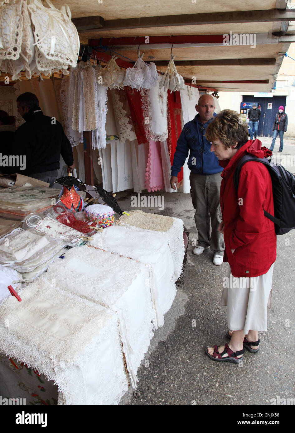 Mature woman looking at stall selling lace open air market Marsaxlokk ...