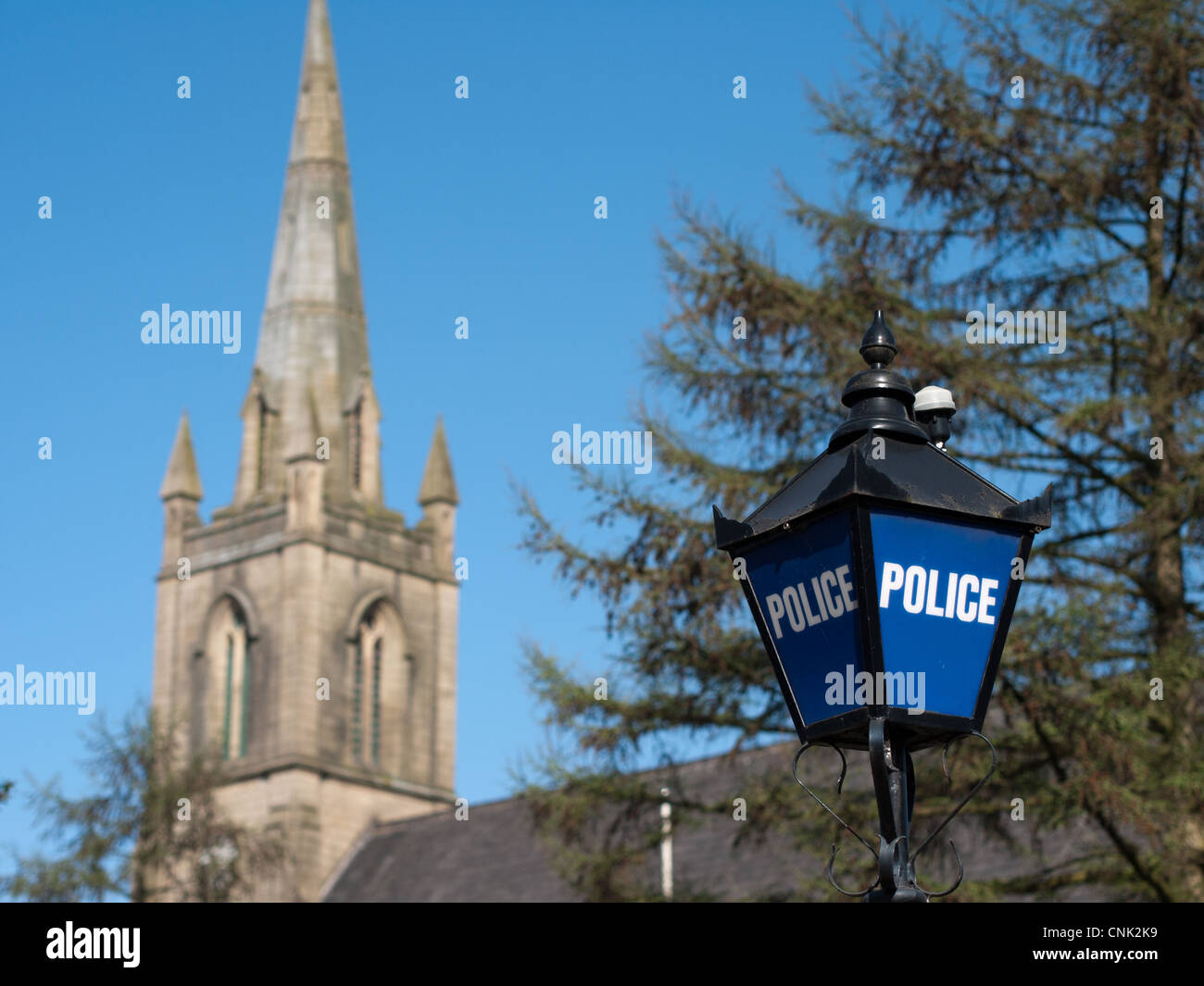 Traditional police station sign with church in background Stock Photo ...