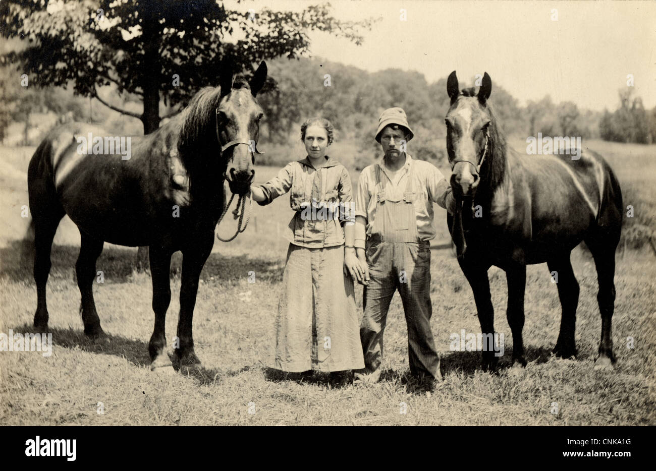 Young Farm Couple Each with a Horse Stock Photo - Alamy