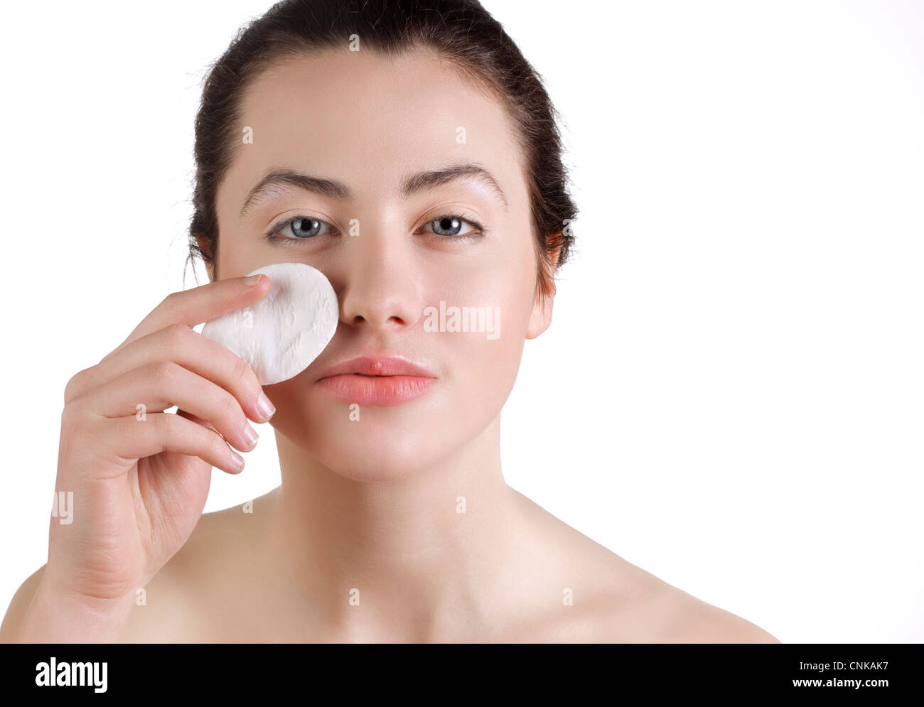 Beautiful young woman cleaning her face with cotton facial pads Stock ...