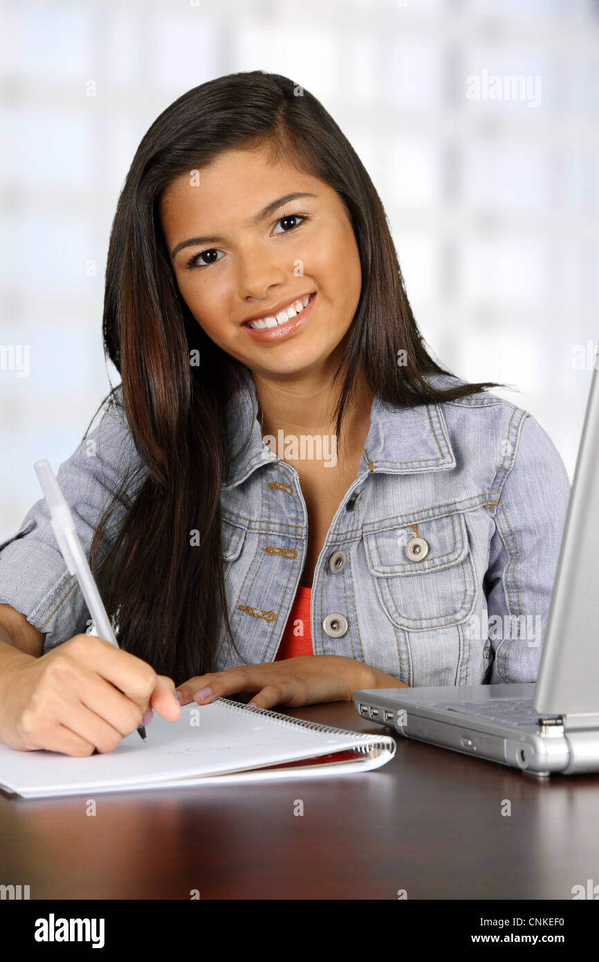 Girl writing at her desk at school Stock Photo - Alamy