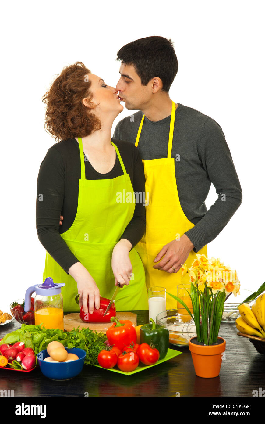 Loving couple kissing in kitchen and cooking together Stock Photo - Alamy