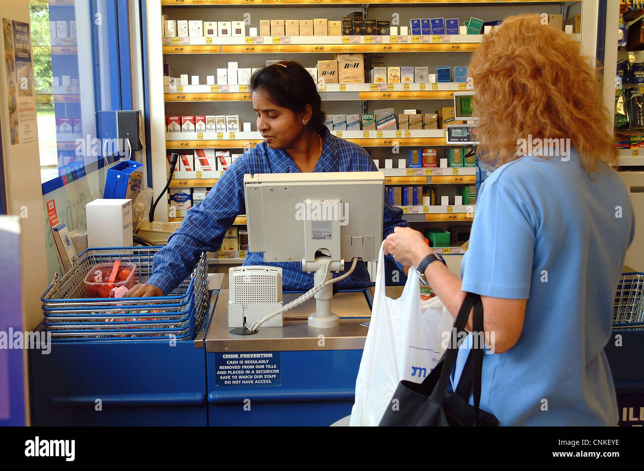 Female shoppers in petrol station Tesco Express convenience store UK ...