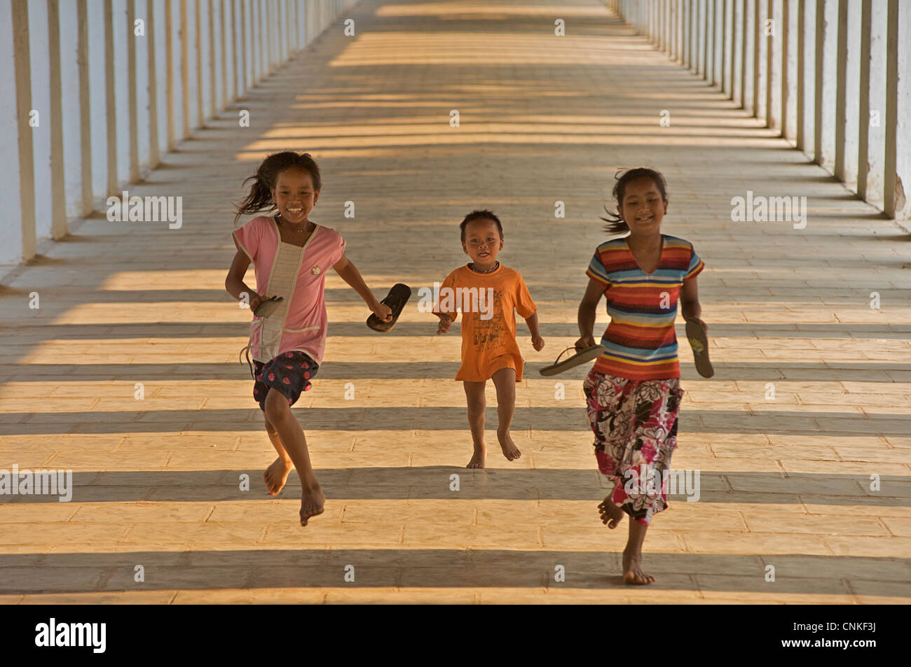 Burmese children running in the corridor at Shwezigon Pagoda, Bagan ...