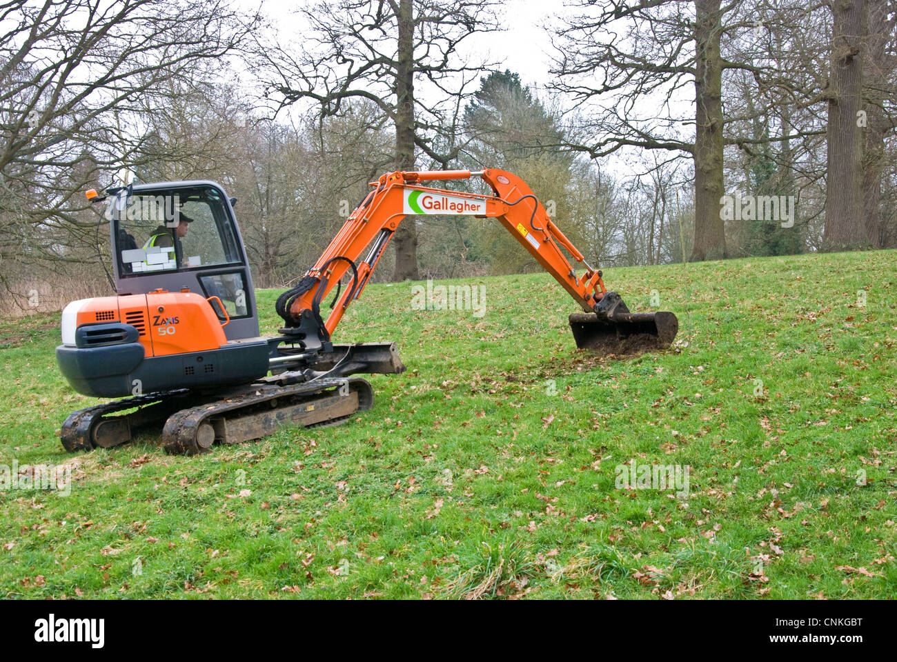 A digger preparing ground for wild flowers Stock Photo - Alamy