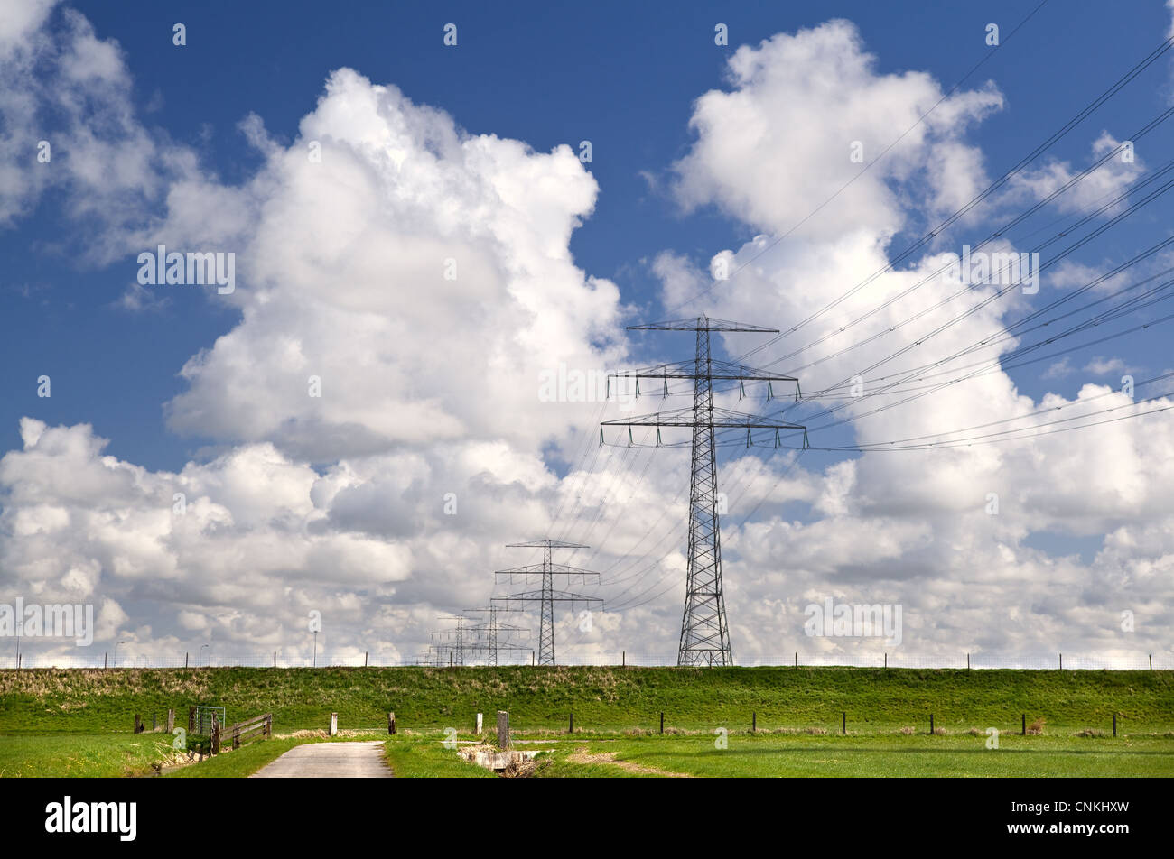 plain Dutch landscape with high-voltage line and beautiful blue sky ...