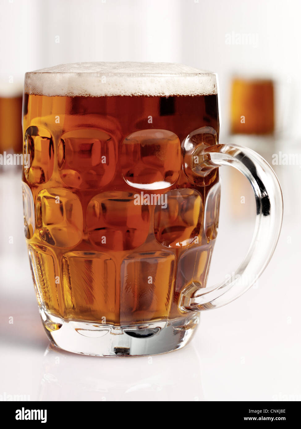 Still life: A pint of ale in a beer glass on white Stock Photo - Alamy