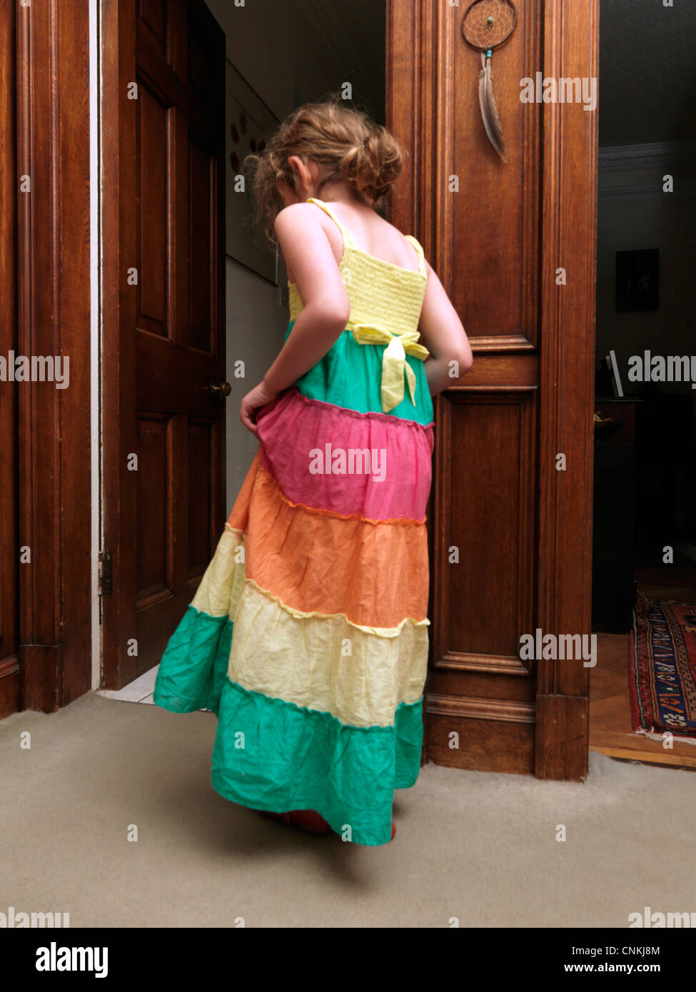 Sneaking girl doorway hi-res stock photography and images - Alamy