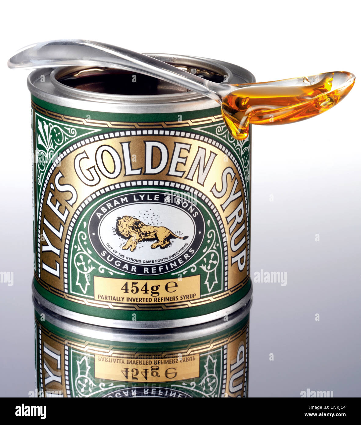 Open can of Lyles Golden Syrup with spoonful Stock Photo - Alamy