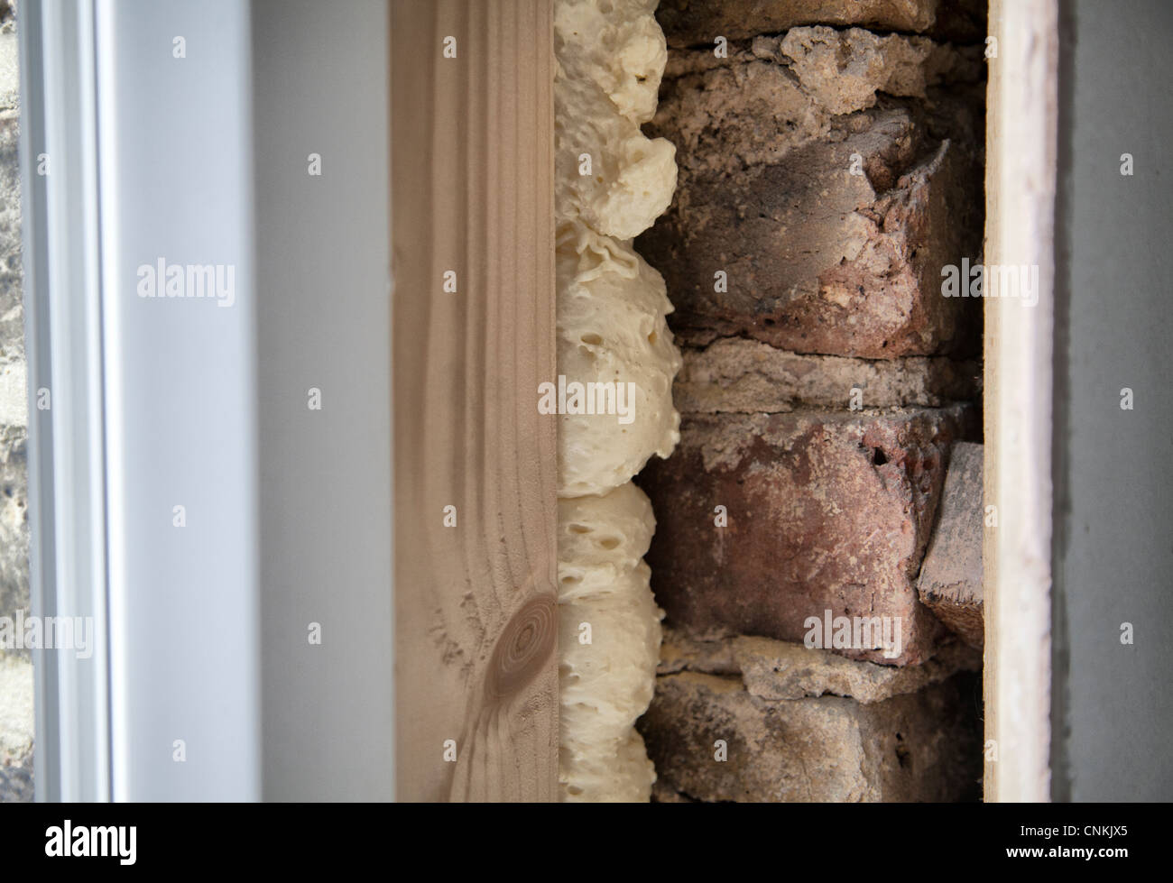 Expandable foam between window frame and brick wall Stock Photo - Alamy