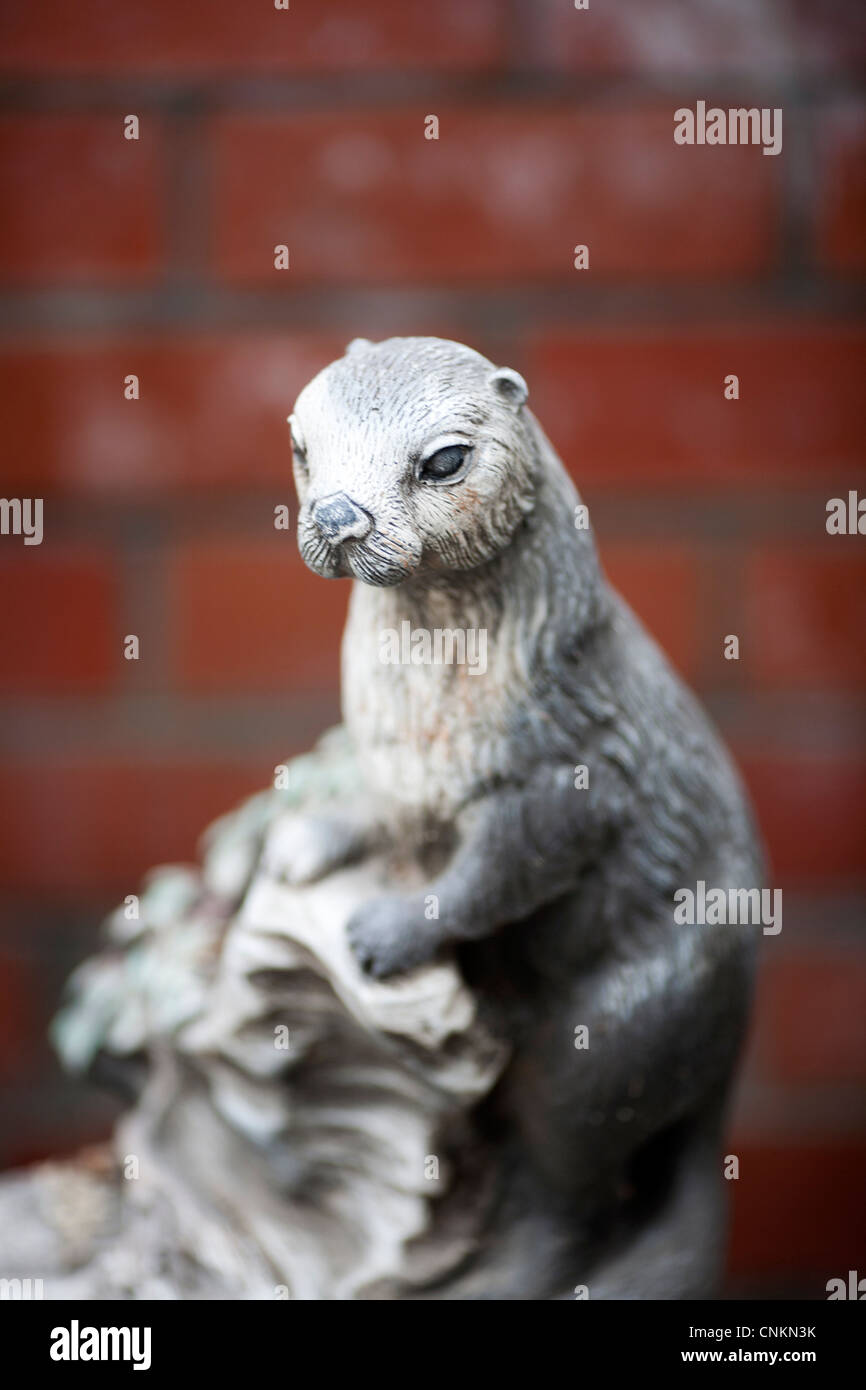 Figurine of Otter in water feature Stock Photo - Alamy