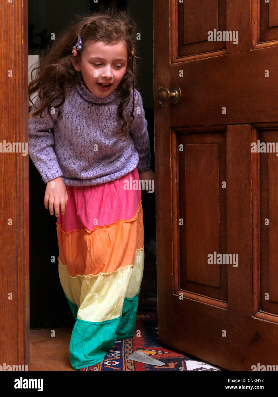 Young Girl Sneaking Through Doorway England Stock Photo - Alamy