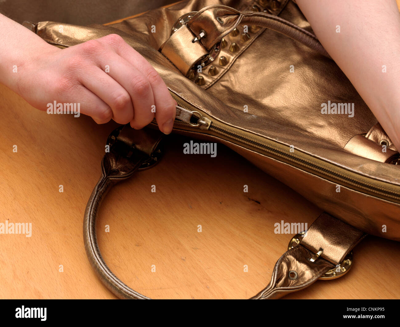 Hands Zipping Up Bag Stock Photo - Alamy