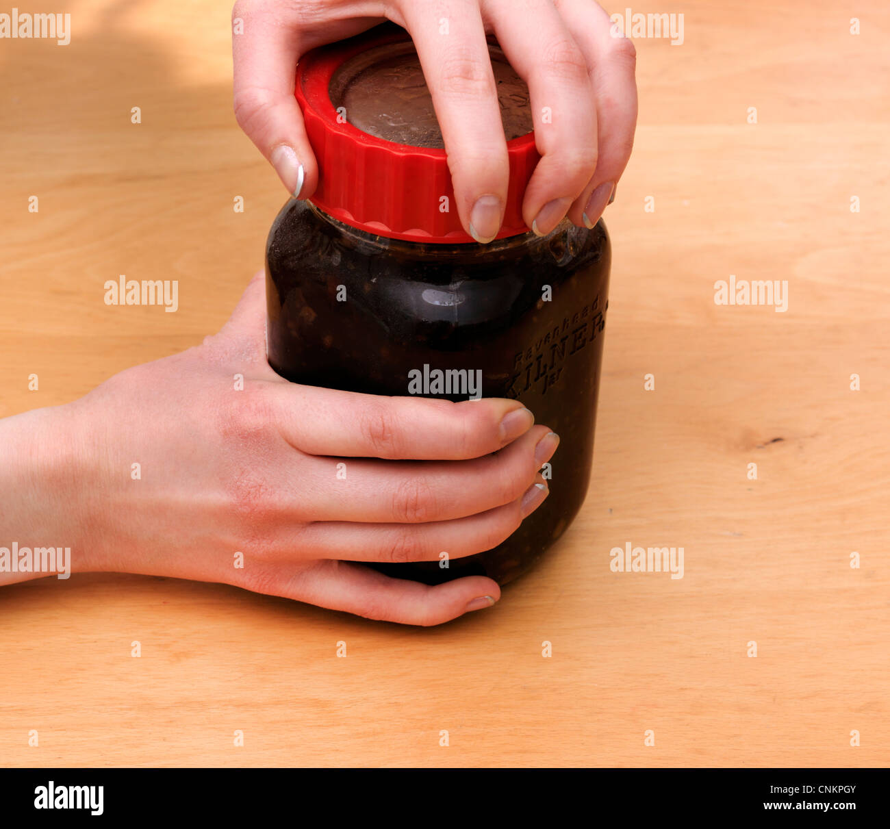 Hands Unscrewing Lid On Jar Stock Photo - Alamy