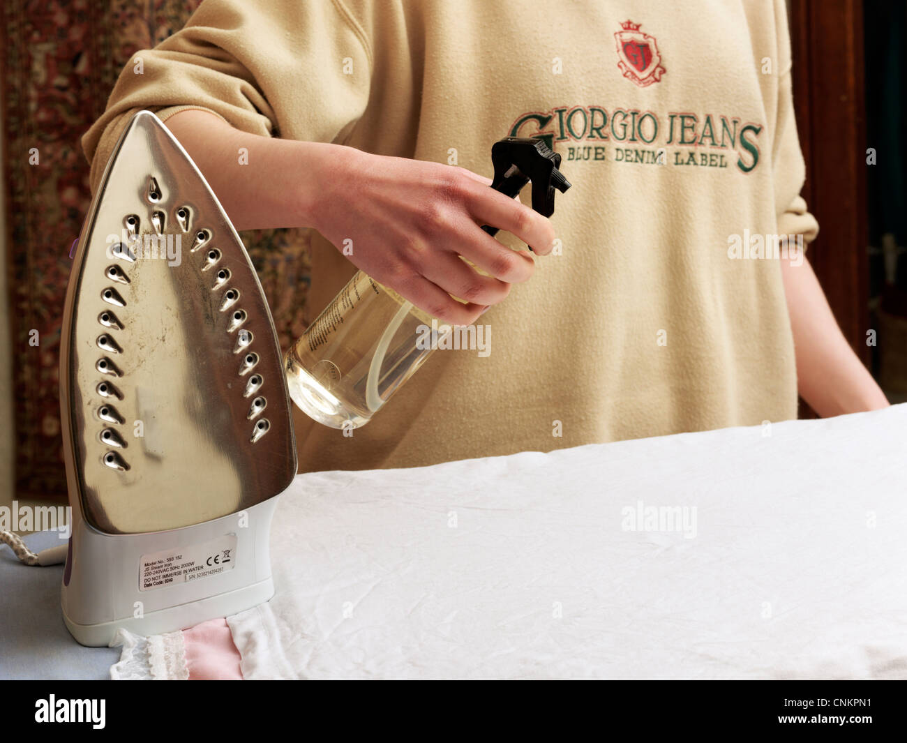 Woman spraying shirt water hi-res stock photography and images - Alamy
