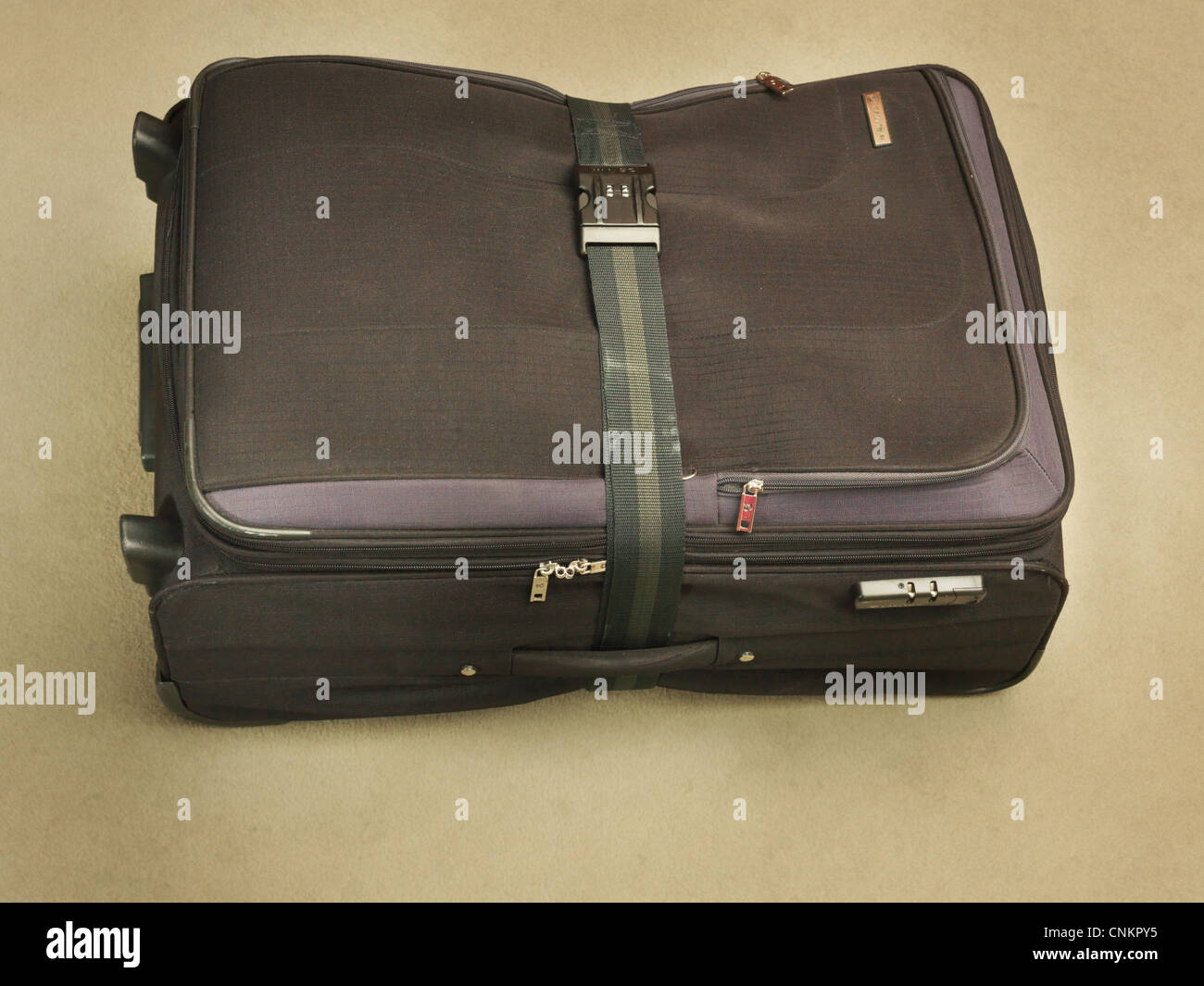 A Strap Tied Tight Around A Full Black Suitcase Stock Photo - Alamy