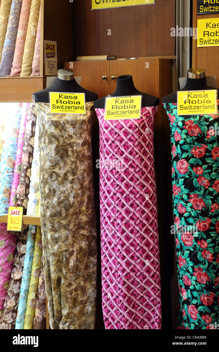 Fabric in rolls in textile shop Stock Photo - Alamy