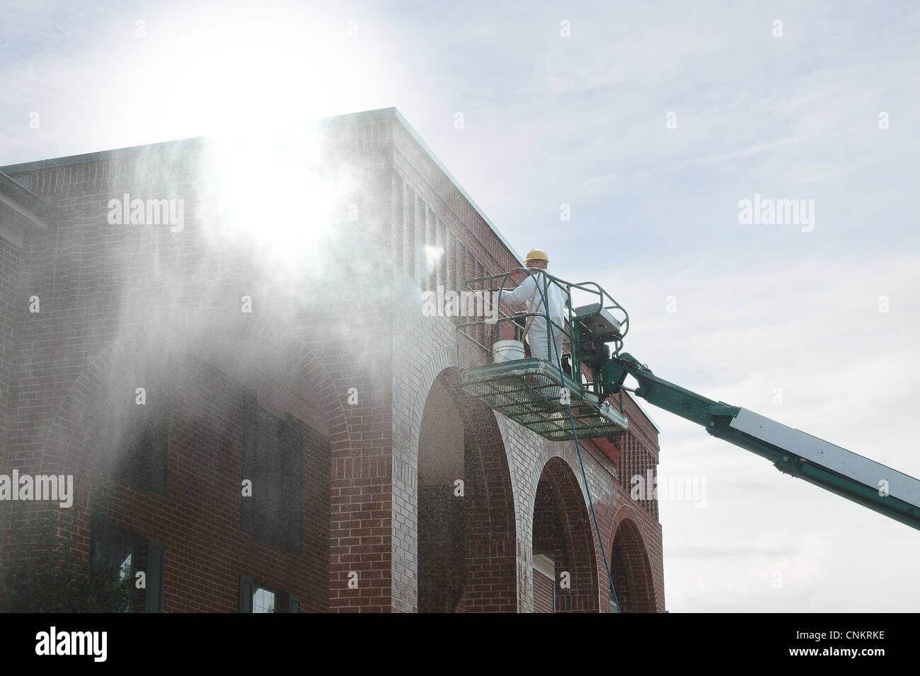 Man power washing building Stock Photo - Alamy