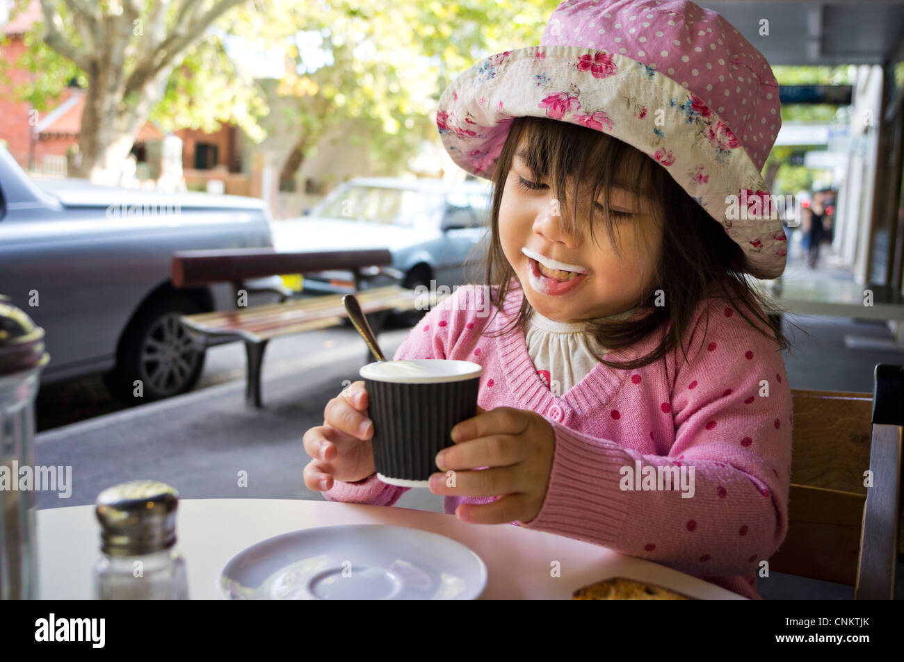 2 year old girl enjoying Baby-Chino Stock Photo - Alamy