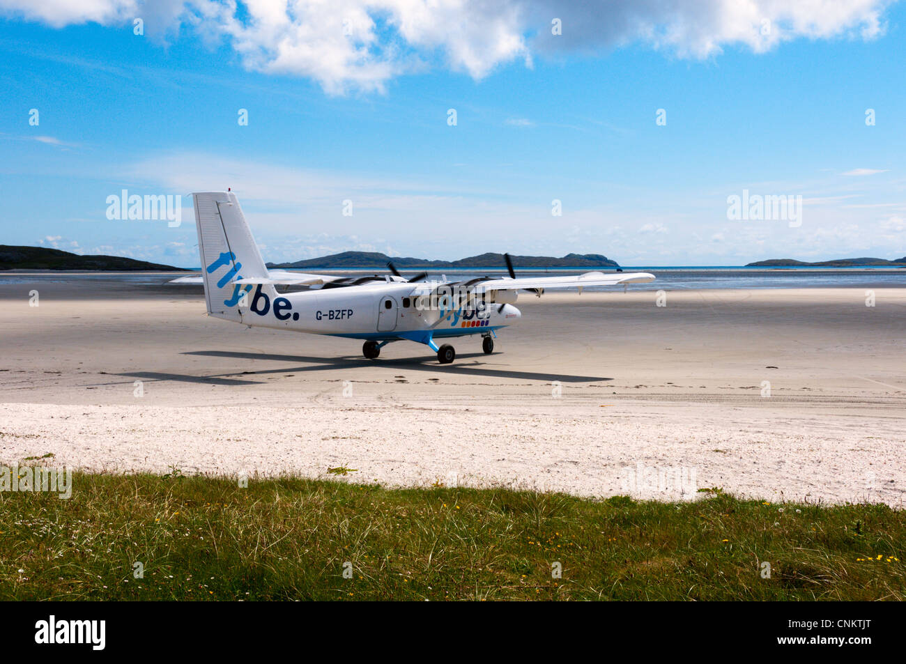 A plane of Flybe - Loganair about to take off from the beach airstrip ...