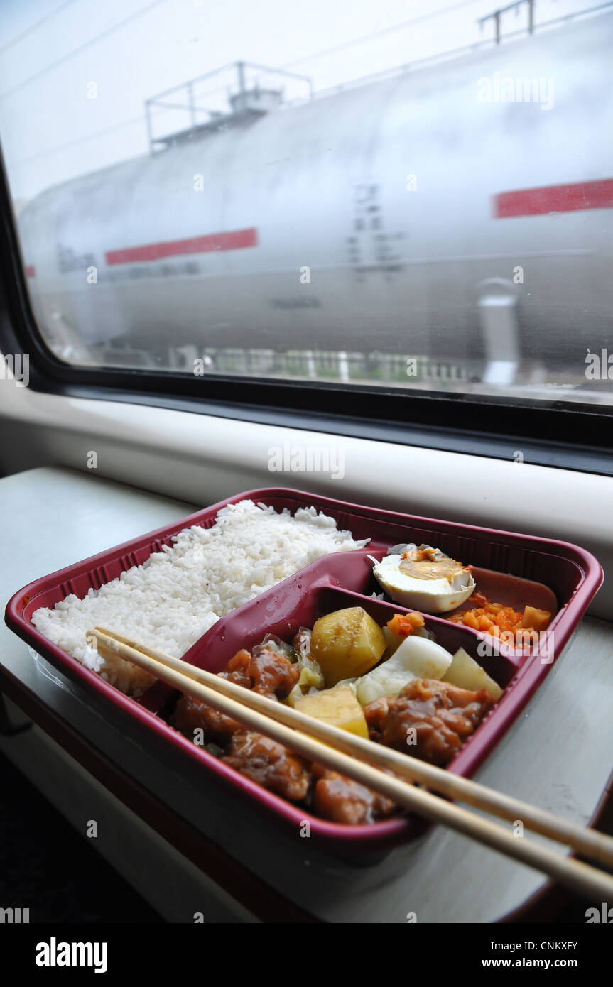 Standard meal of rice, chicken and vegetables onboard a Chinese train ...