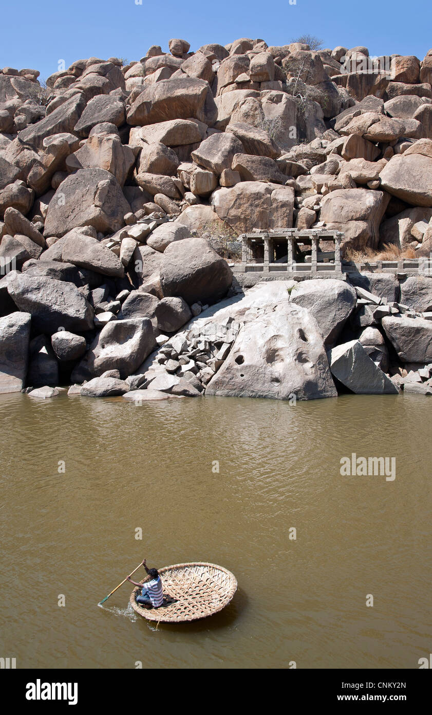 Man paddling a traditional boat (coracle). Tungabhadra river. Hampi ...