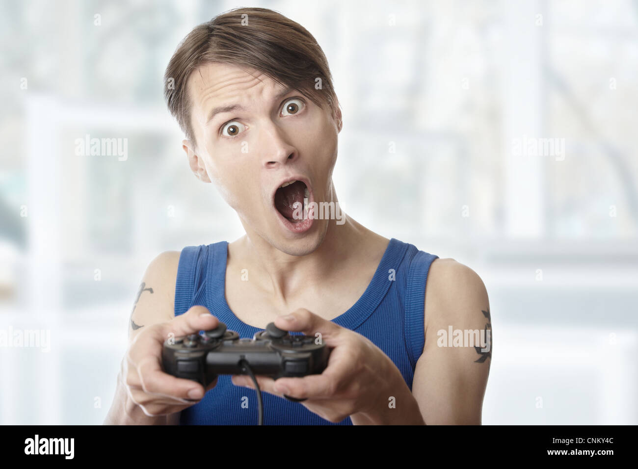 Man playing computer games at home using joystick Stock Photo - Alamy