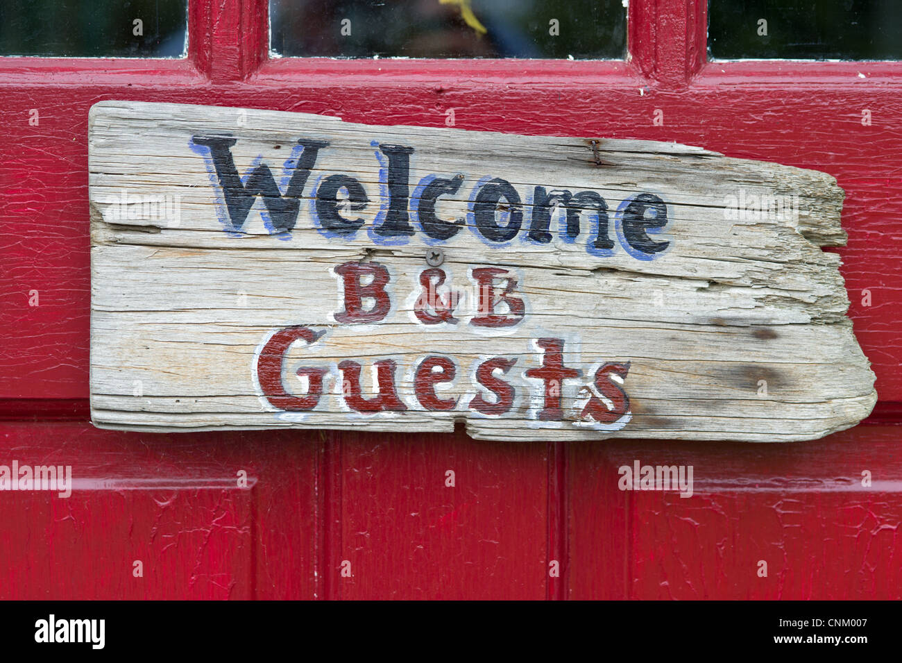 A welcome sign for a bed and breakfast on the front door Stock Photo ...