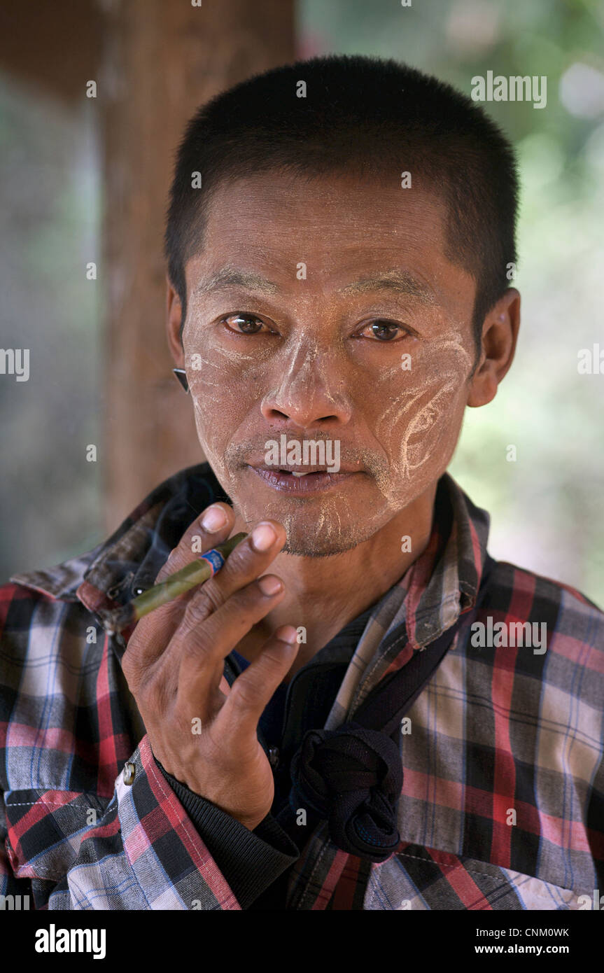 Portrait of a Burmese man with Thanaka painted face. A distinctly ...