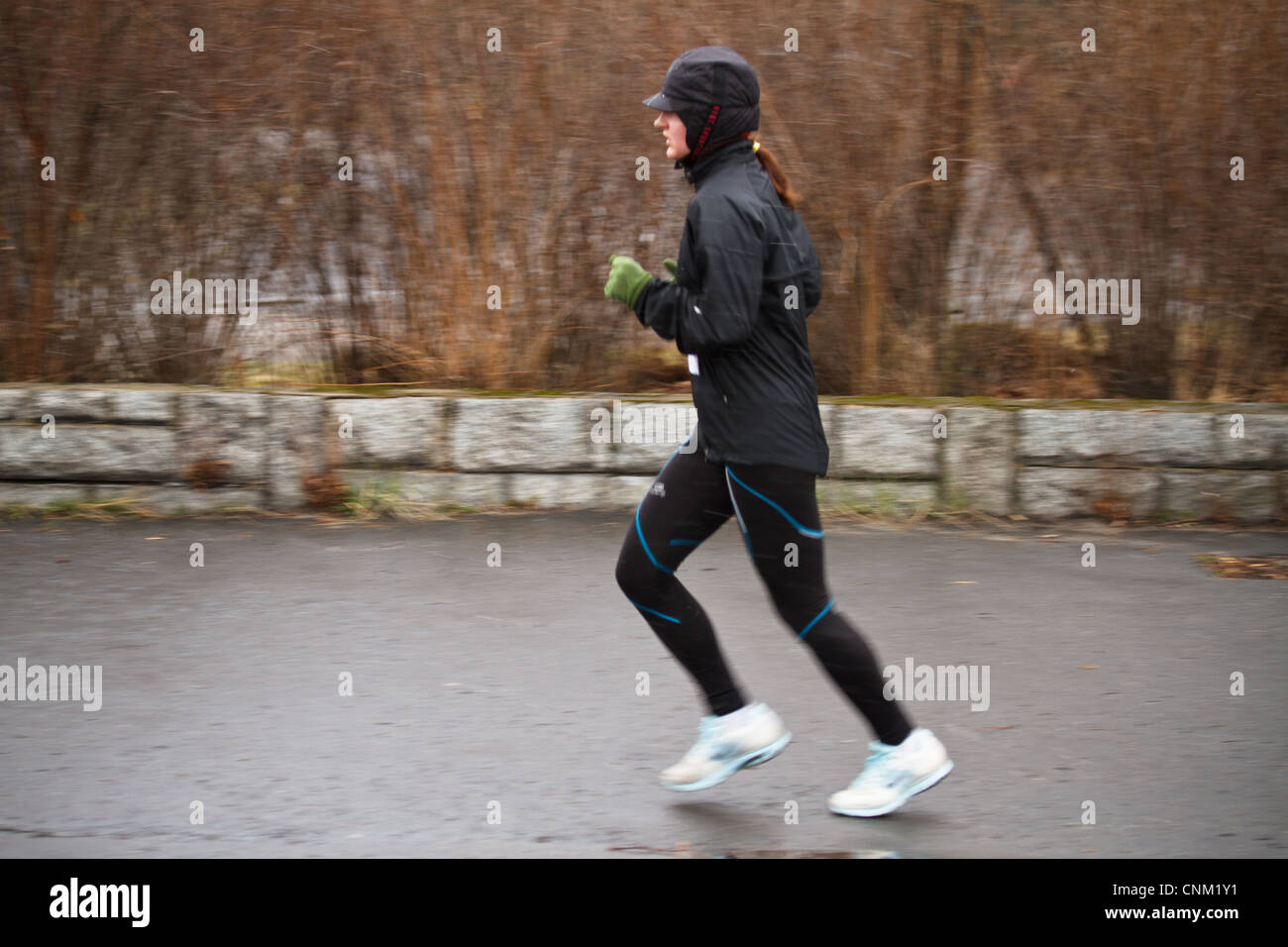 Girl running in bad weather Stock Photo - Alamy