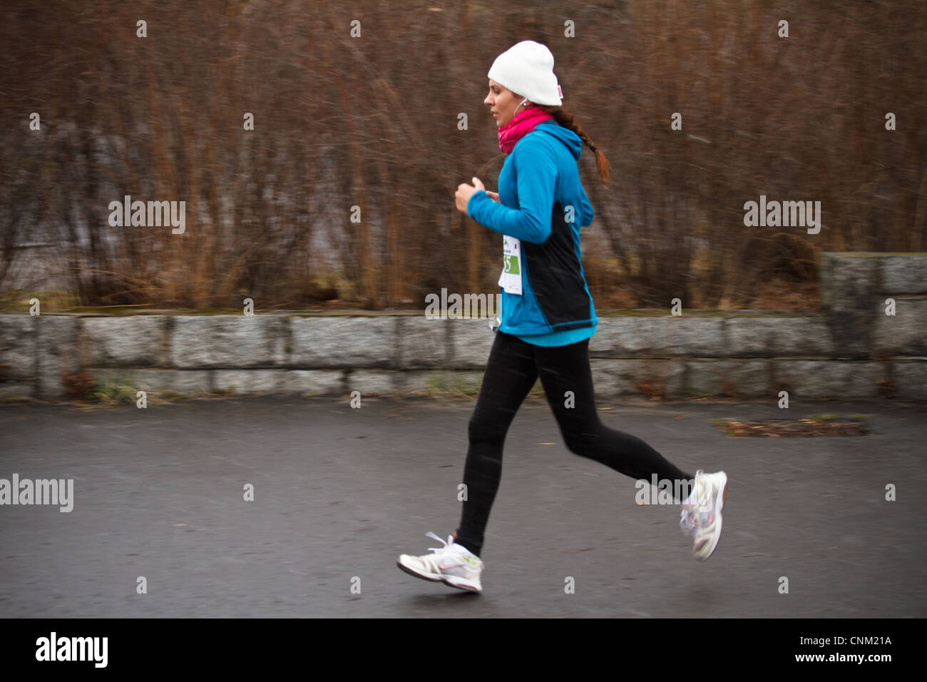 Girl running in bad weather Stock Photo - Alamy
