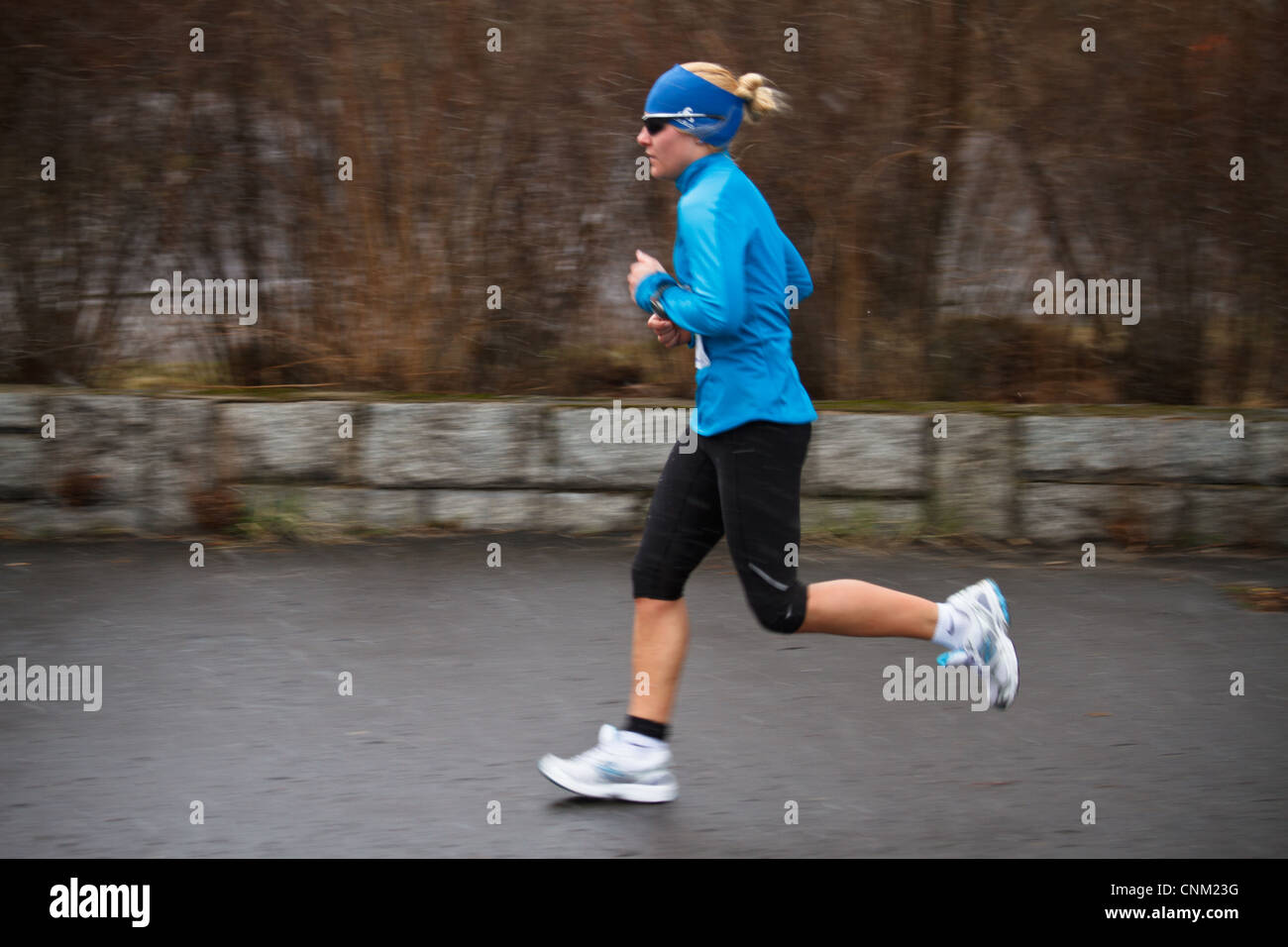 Girl running in bad weather Stock Photo - Alamy