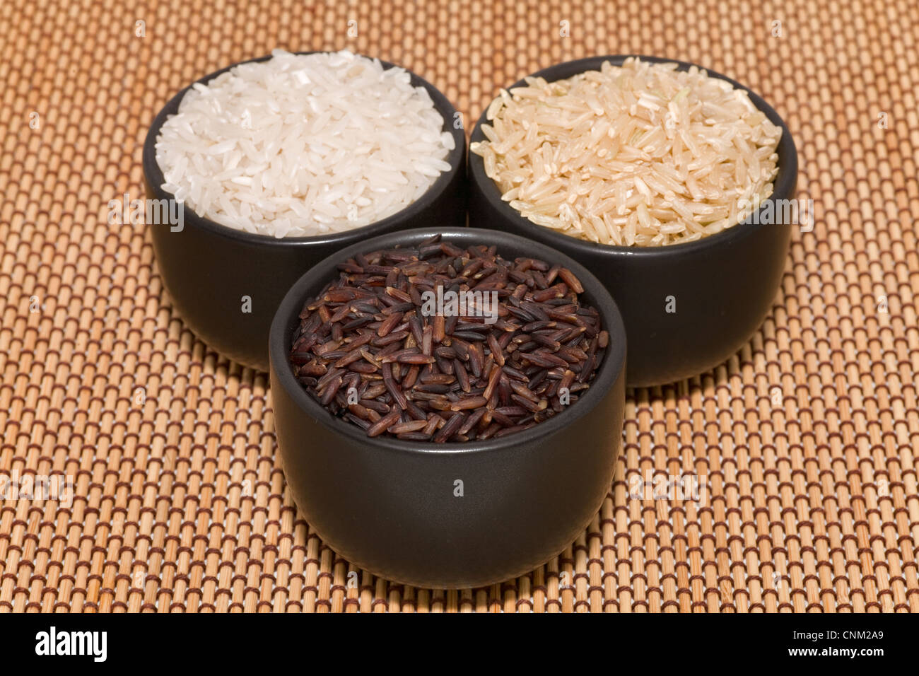 raw black, brown and white rice in bowls Stock Photo - Alamy