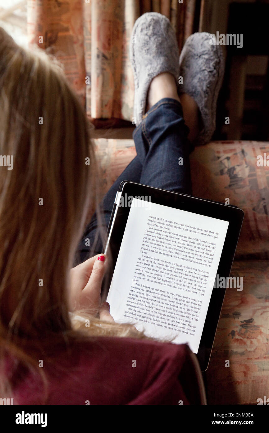 Woman reading ipad on sofa hi-res stock photography and images - Alamy