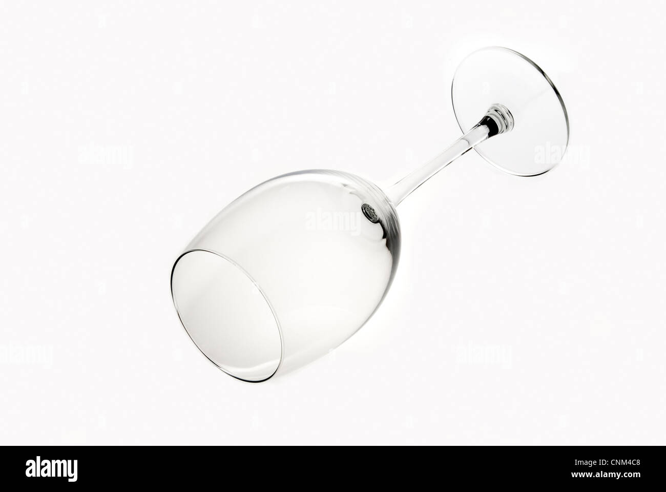 Empty wine glass lying on it's side Stock Photo - Alamy