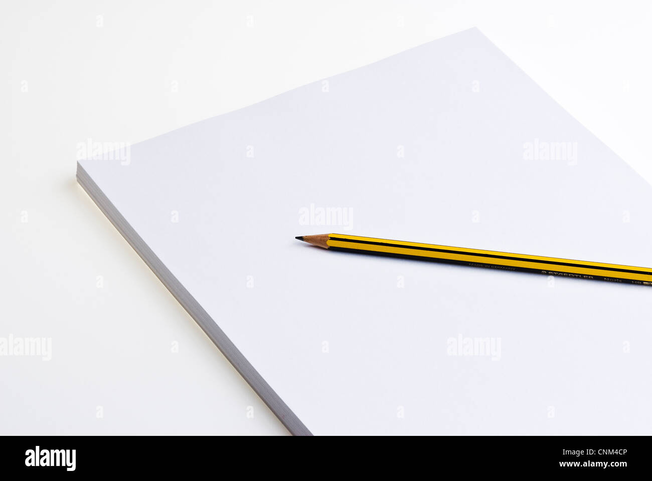 Blank pad of white paper with a pencil on a white background Stock ...