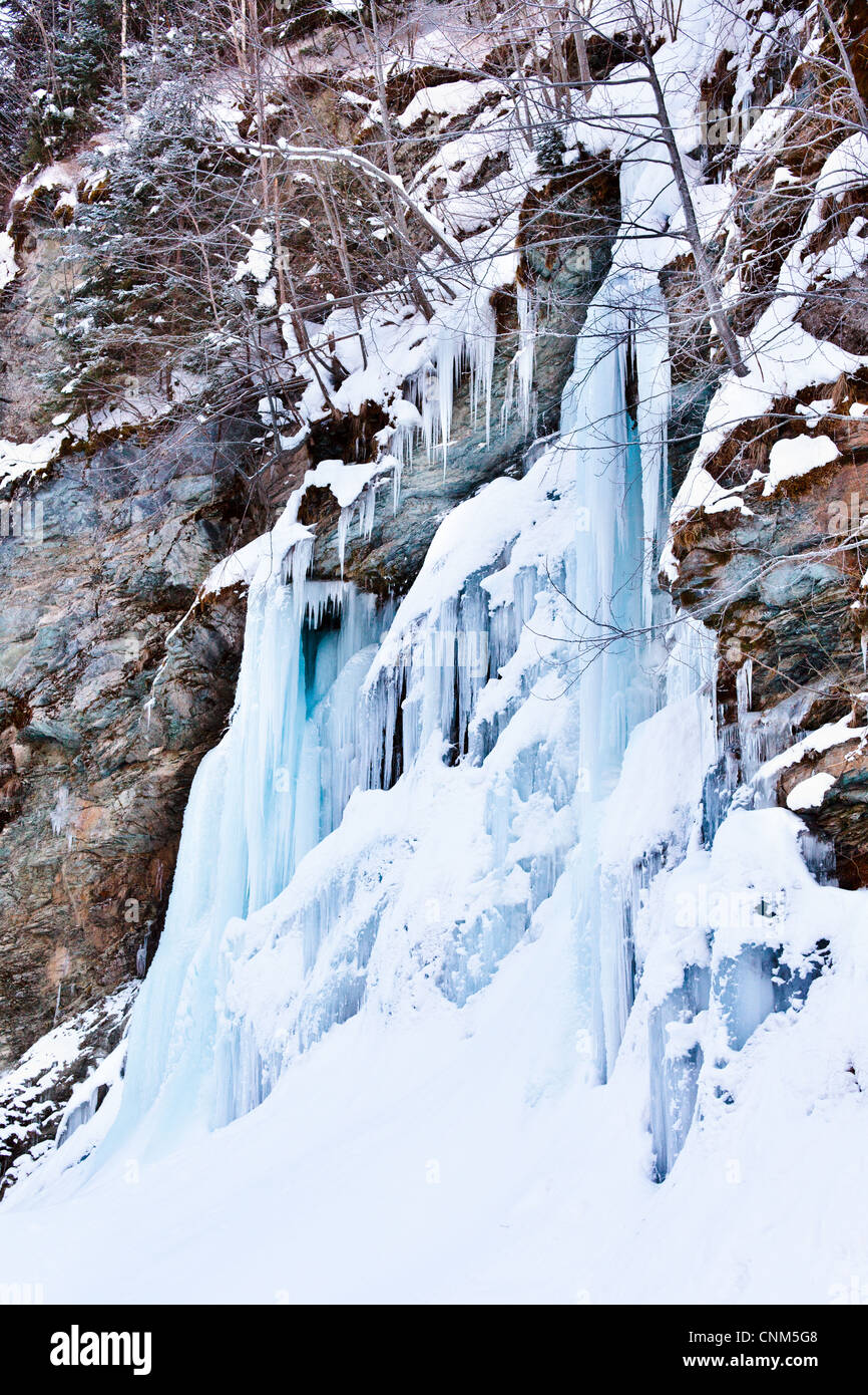 Huge icicles formed in a waterfall on a mountain Stock Photo - Alamy