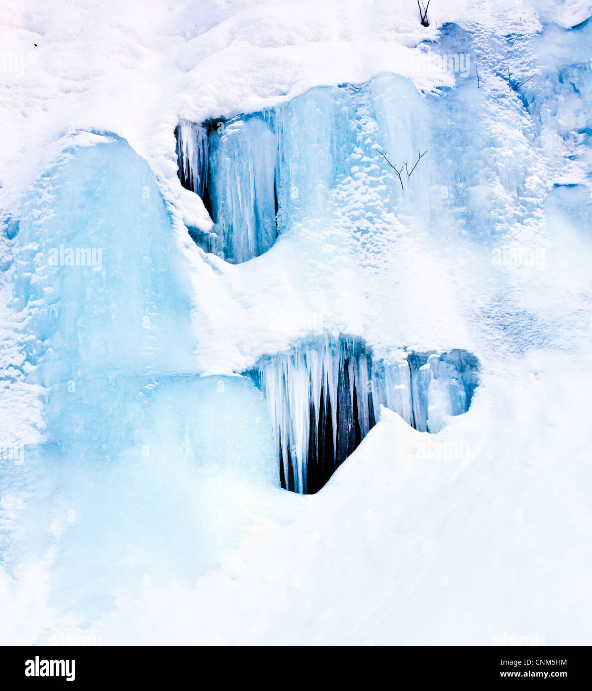 Huge icicles formed in a waterfall on a mountain Stock Photo - Alamy