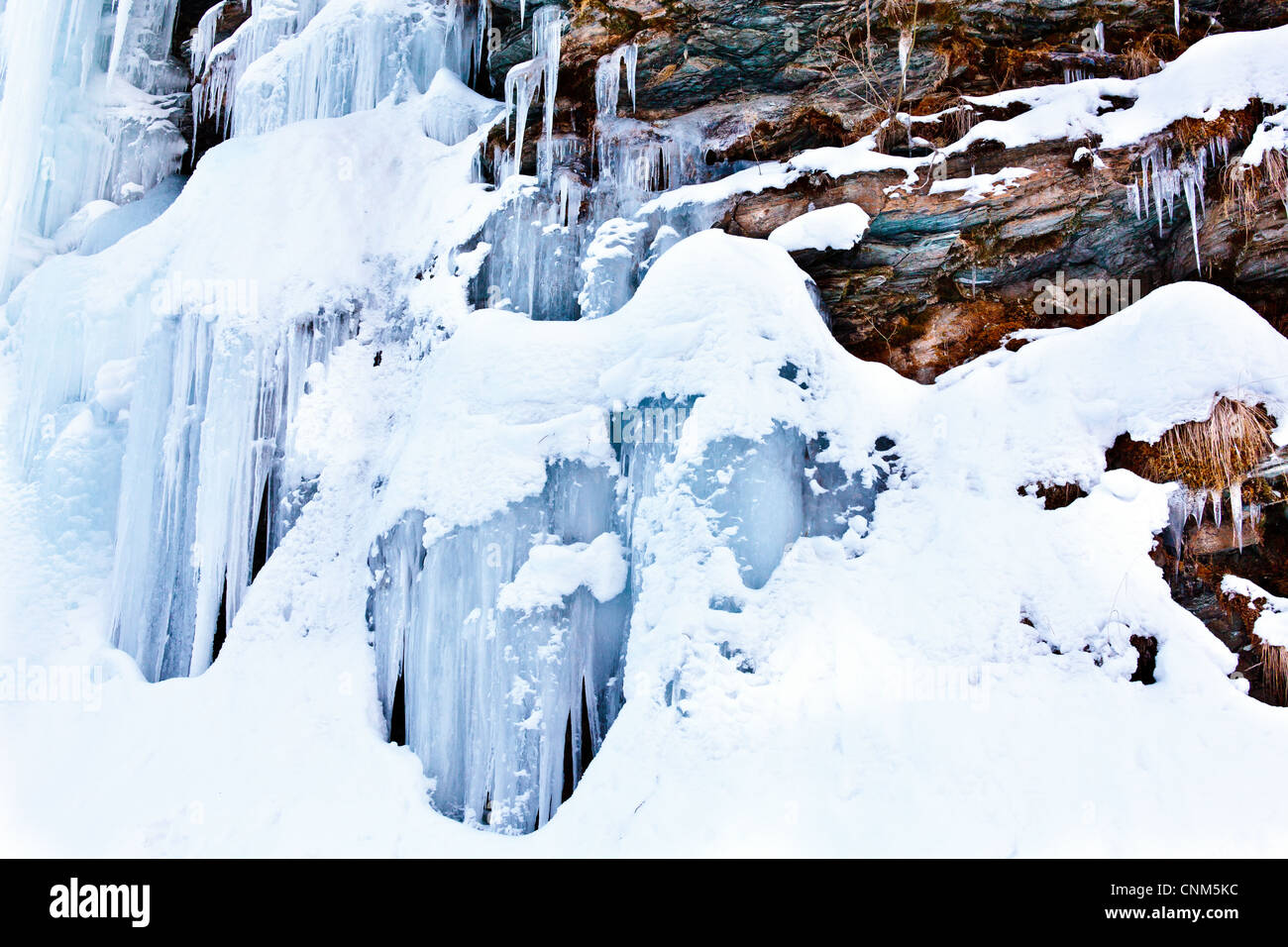 Huge icicles formed in a waterfall on a mountain Stock Photo - Alamy